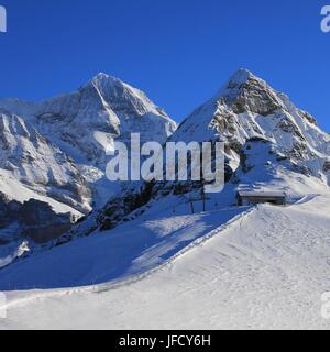 Snow covered mountains Monch, Lauberhorn and Jungfrau. Chair lift and ...