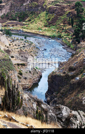 Bridge over mountain river in winter time Stock Photo - Alamy