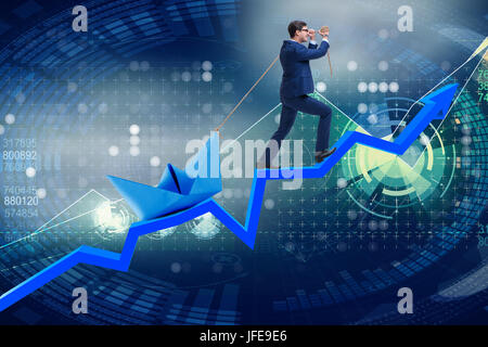 Businessman pulling boat over line chart Stock Photo - Alamy