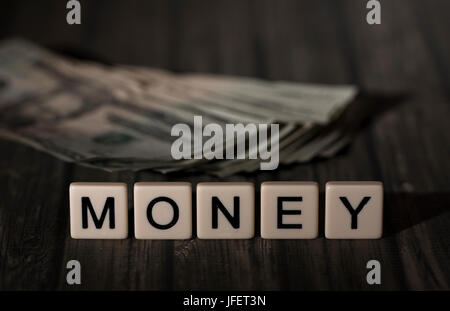 Money Spelled Out in Tiles Stock Photo - Alamy