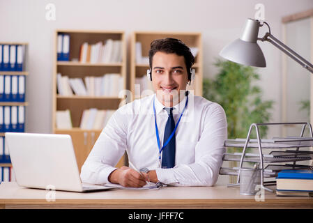 Handsome customer service clerk with headset Stock Photo - Alamy