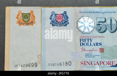 Singapore banknotes (50-100 SGD) on the granite floor - currency ...