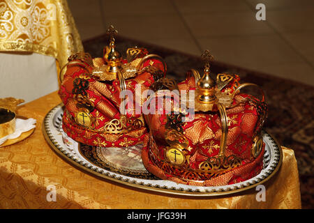 Orthodox wedding crowns and religious symbols set on altar for sacred ...