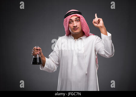 Arab with oil on gray background Stock Photo - Alamy