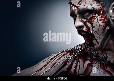 Creepy man with bloody scars face, Halloween stylish zombie make-up ...