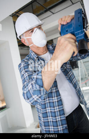 Tradesman using a power tool Stock Photo - Alamy