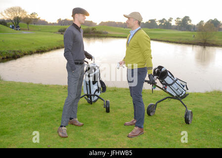 Golfers chatting on the golf course Stock Photo - Alamy