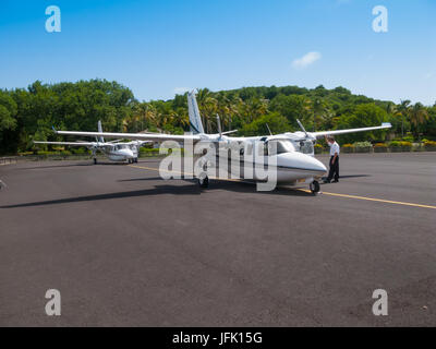 Passengers boarding the aircraft at Mustique Airport, Mustique Stock ...
