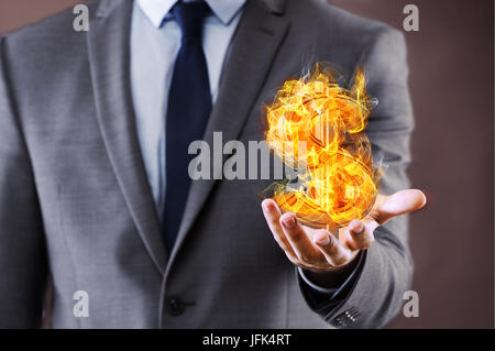 Businessman holding burning american dollar sign Stock Photo - Alamy