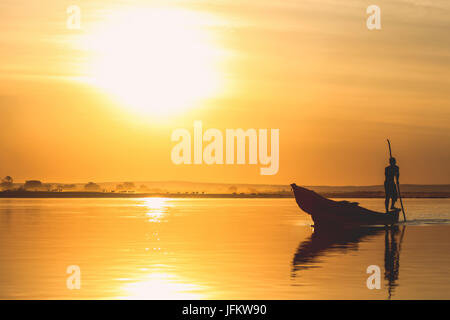 Pirogue at sunset Stock Photo - Alamy