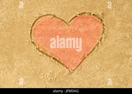 heatr shape drawing in sand background Stock Photo - Alamy