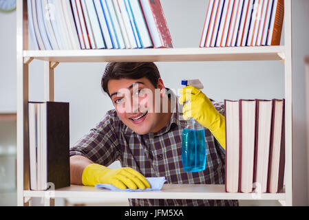 Man cleaning dust from bookshelf Stock Photo - Alamy