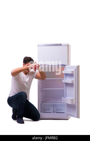 Hungry man looking for money to fill the fridge Stock Photo - Alamy