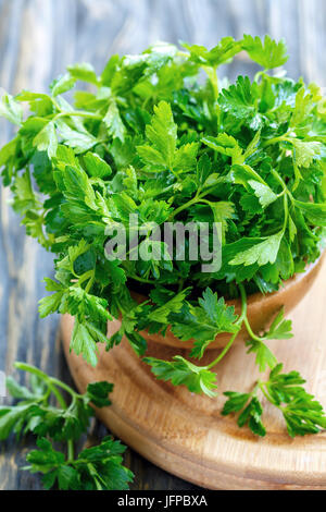 Fresh parsley leaves with drops of water and radish in one of the ...