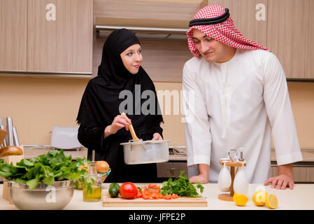 The young arab family in the kitchen Stock Photo - Alamy