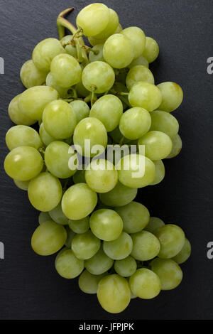 Bunch of ripe grapes on grey wooden background Stock Photo - Alamy