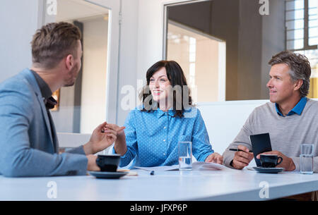 Three confident business colleagues Stock Photo - Alamy