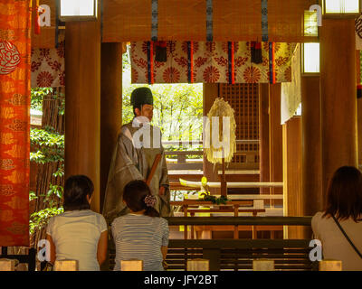 Shinto ritual. Hikawa Shrine, Omiya. Two Japanese women bow as a Shinto ...