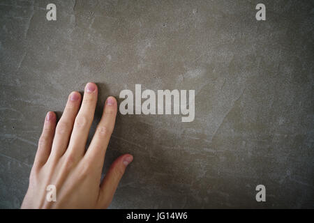 young man hand touching concrete wall, closeup photo Stock Photo - Alamy
