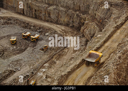 Vehicles working in open cut mine Stock Photo - Alamy