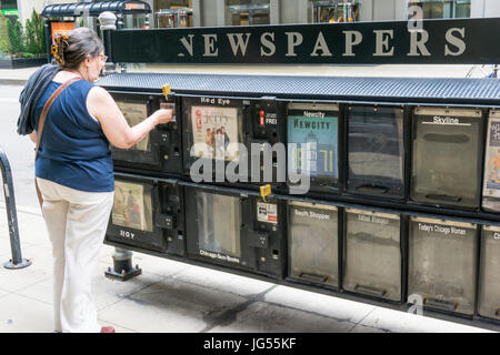 Newspaper dispenser vending machines in a row on a sidewalk Stock Photo ...