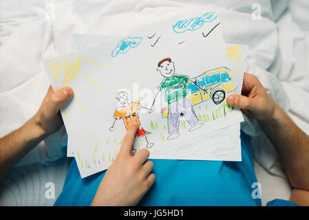little son showing sick father his drawings at ward, dad and son Stock ...