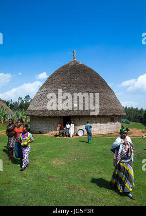 People in front of a Gurage traditional house with thatched roof ...