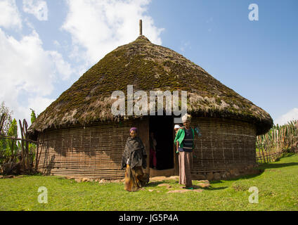 People in front of a Gurage traditional house with thatched roof ...