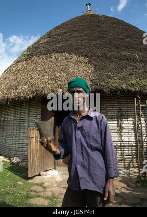 People in front of a Gurage traditional house with thatched roof ...