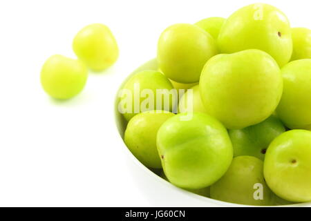 composition of fresh turkish can erik plum fruits in a small white bowl ...