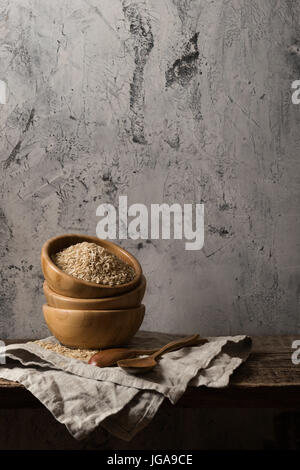 Composition with bowl of rice on wooden table Stock Photo - Alamy