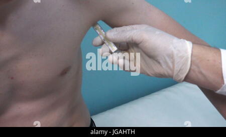 upset woman with thermometer under her arm checking temperature Stock ...