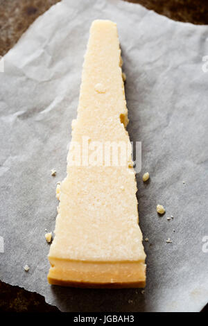 A block of parmesan cheese on parchment paper Stock Photo - Alamy