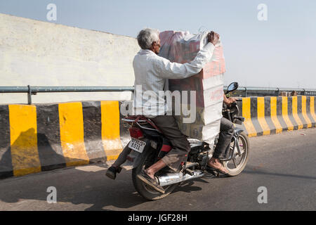 Indian male riding an overloaded motorcycle Stock Photo - Alamy