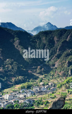 Mountains with garden and village houses and a cloudy sky in mazandaran ...