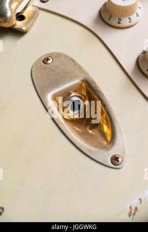 Gold vintage style tuner of vintage guitar againt concrete background ...