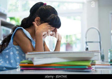Side view of shocked child in pajama looking at Christmas stocking near ...