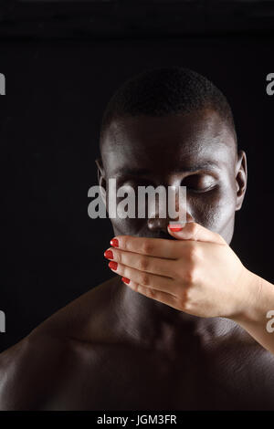 African Man Covering Mouth With Hand Posing Over White Background Stock ...