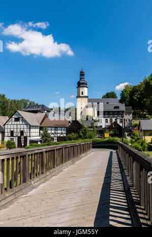 Wooden bridge over the river Saale, view to village with church ...