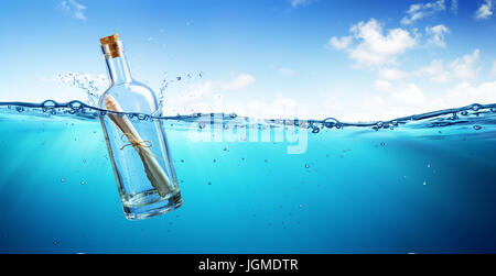 Message in a bottle floating in ocean Stock Photo - Alamy