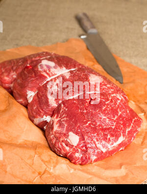 Piece of raw red beef chuck meat with fat. Red meat is prepared for a ...