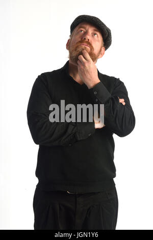 Thinking handsome ginger guy posing and looking upward isolated over ...