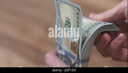 closeup man hands flipping dollars Stock Photo - Alamy