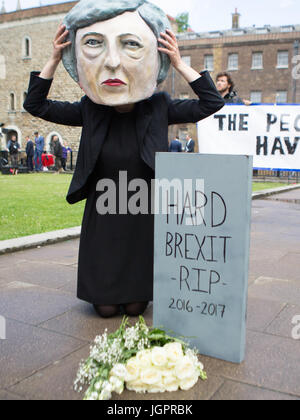 Theresa May big head kneeling next to 'hard brexit RIP' gravestone on ...