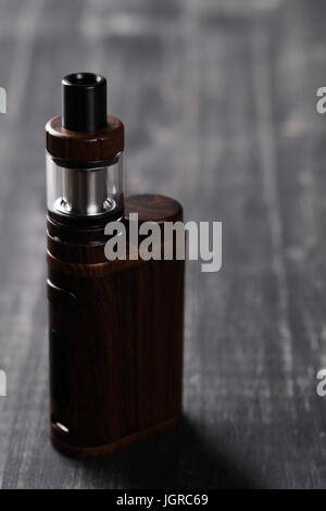 Vaping device on the wooden table Stock Photo - Alamy