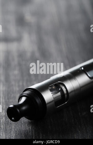 Vaping device on the wooden table Stock Photo - Alamy