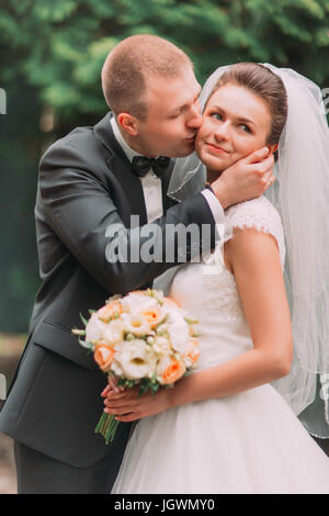 Affectionate hugging outdoors in elegant city square, lifestyle ...