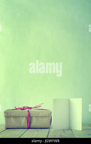 Blank gift greeting card with gift box present and bright shiny golden ...