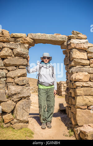 Tourist exploring the ancient mysterious Inca labyrinth-like settlement ...
