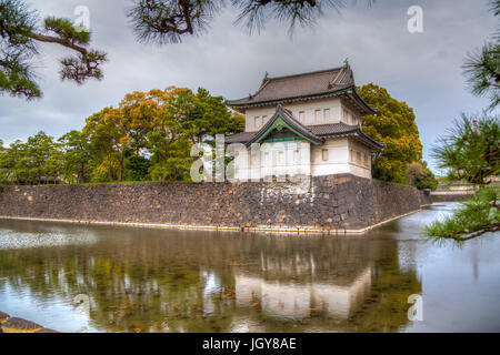 The Imperial Palace buildings reflected in the moat in Tokyo, Japan ...
